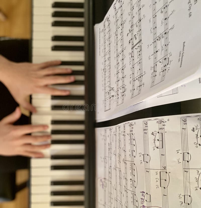 Student Playing the Piano Looking at the Notes Stock Photo - Image of ...