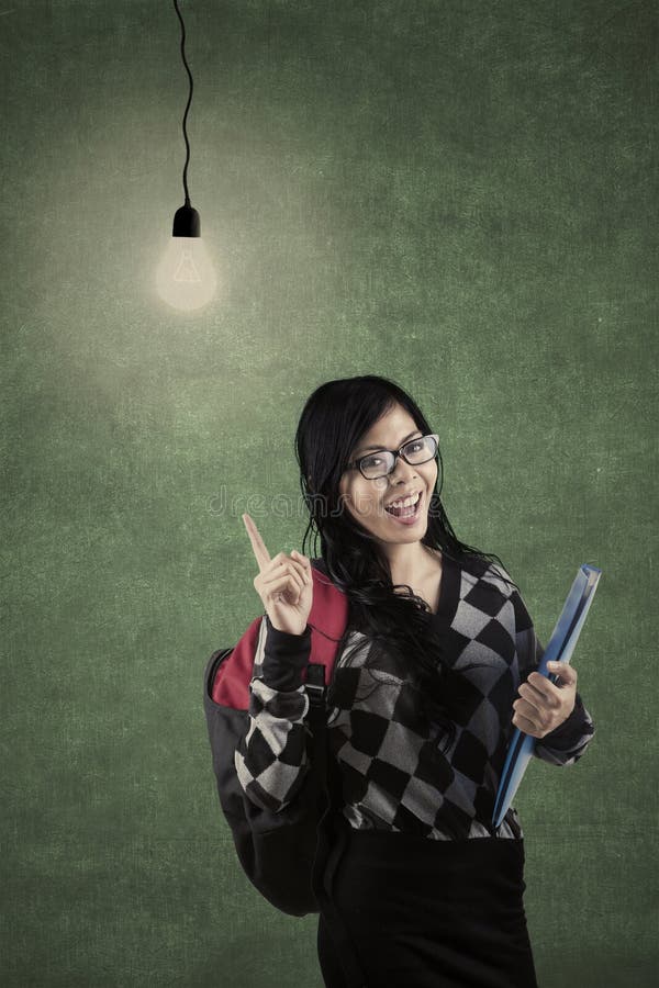 Student Pointing at Bright Lamp Stock Image - Image of class ...