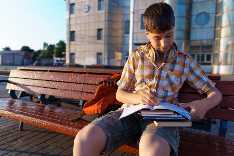 A Student Poses at a Railway Station, a Boy is Waiting for a Train on ...