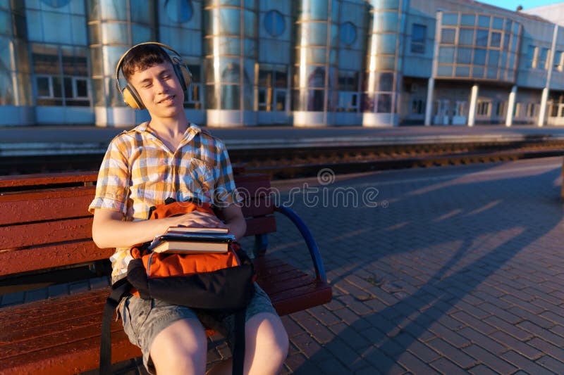 A Student Poses at a Railway Station, a Boy is Waiting for a Train on ...