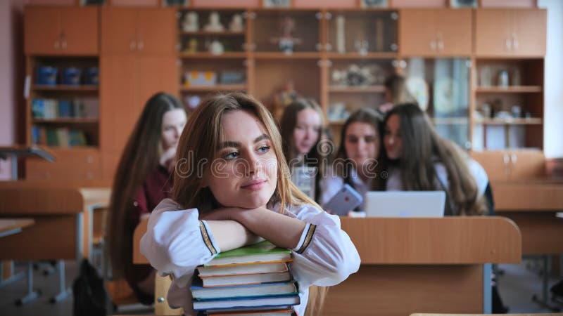 A Student Poses with Textbooks at Her Desk in Her Class. Stock Image ...