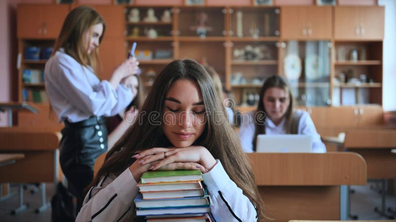A Student Poses with Textbooks at Her Desk in Her Class. Stock Image ...