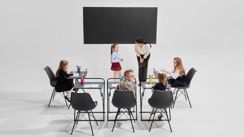 Student Presenting in Front of Classroom while Teacher Listens Kindly ...