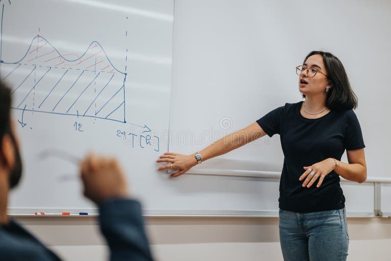 Student Presenting Graph Data on Whiteboard during Classroom Session ...