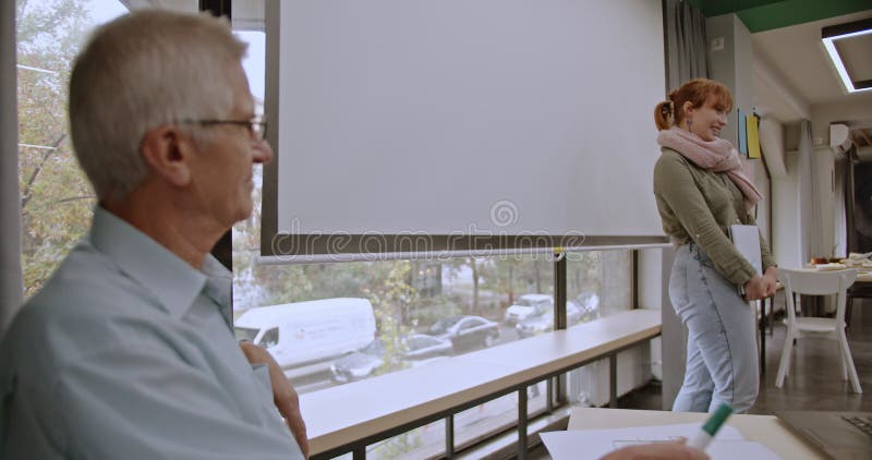 A Student Gives a Presentation To Her Professor after Class. they are ...