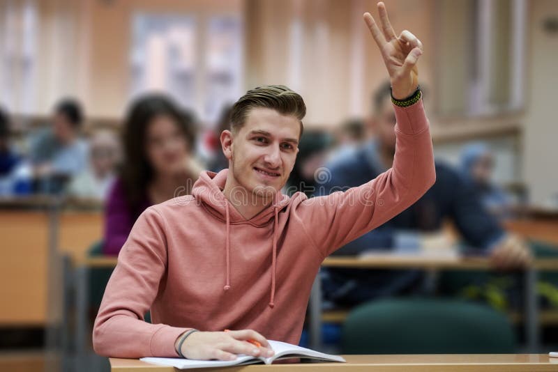 The Student Raises His Hands Asking a Question in Class in College ...