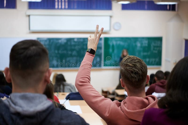 The Student Raises His Hands Asking a Question in Class in College ...