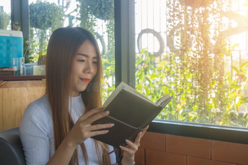 Student Reading Book in Cafe. Stock Image - Image of modern, emotional ...