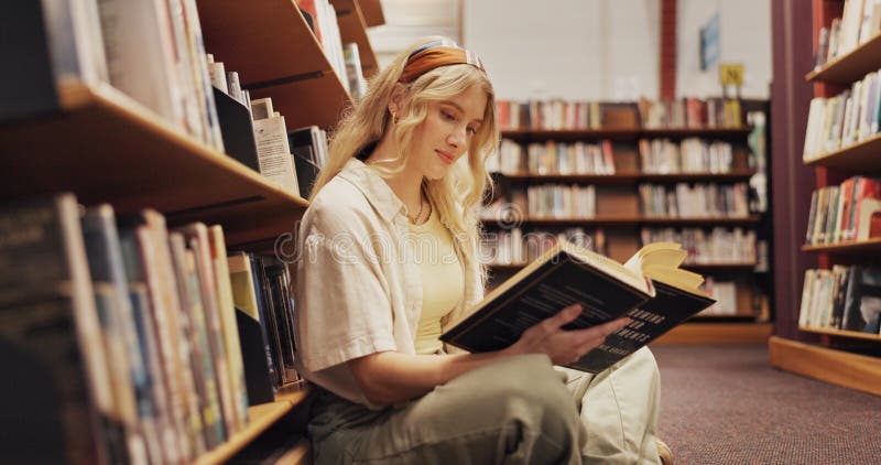 Student, Reading and Book on Floor in Library for Learning, Financial Study and Business Course ...