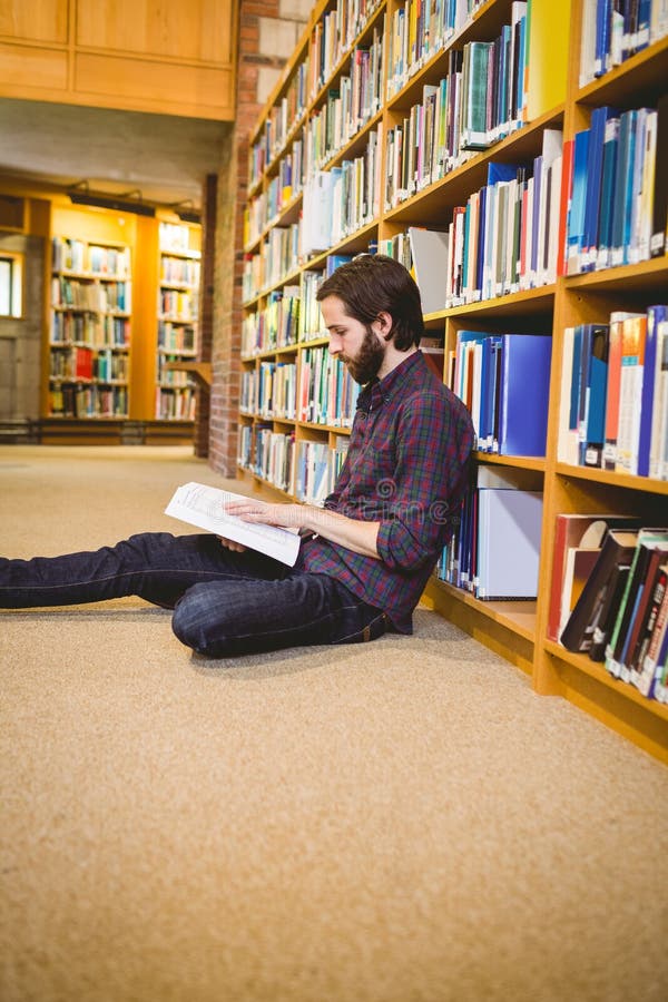 Student Reading Book in Library on Floor Stock Photo - Image of ...