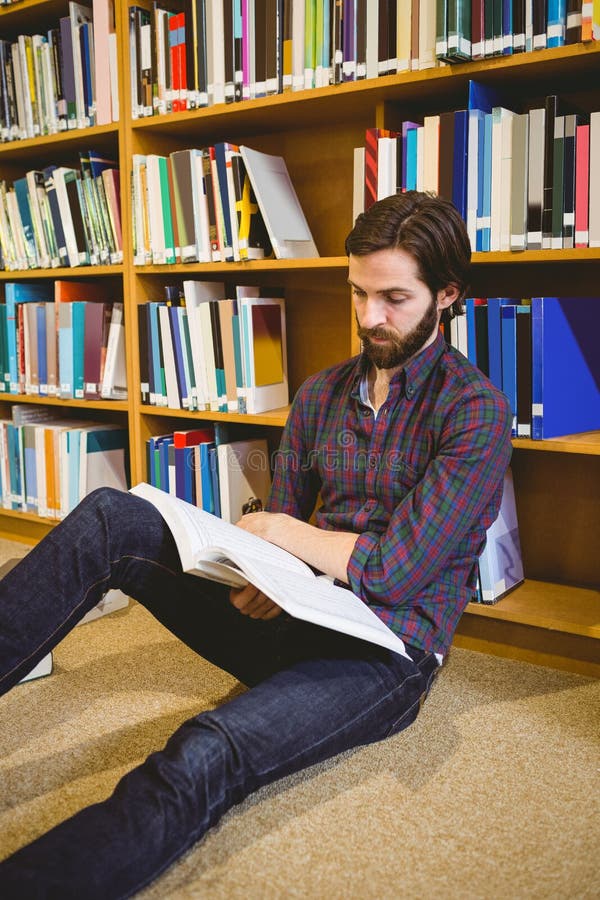 Student Reading Book in Library on Floor Stock Photo - Image of ...
