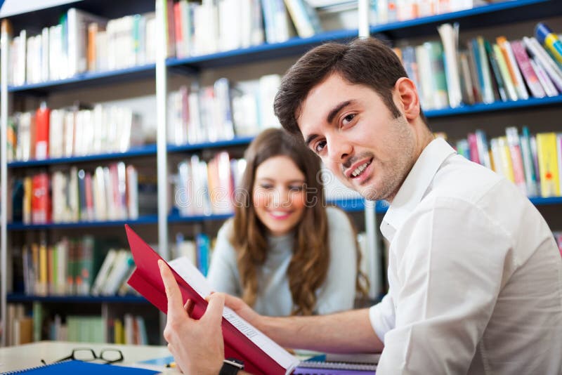 Student Reading a Book in a Library Stock Photo - Image of library ...