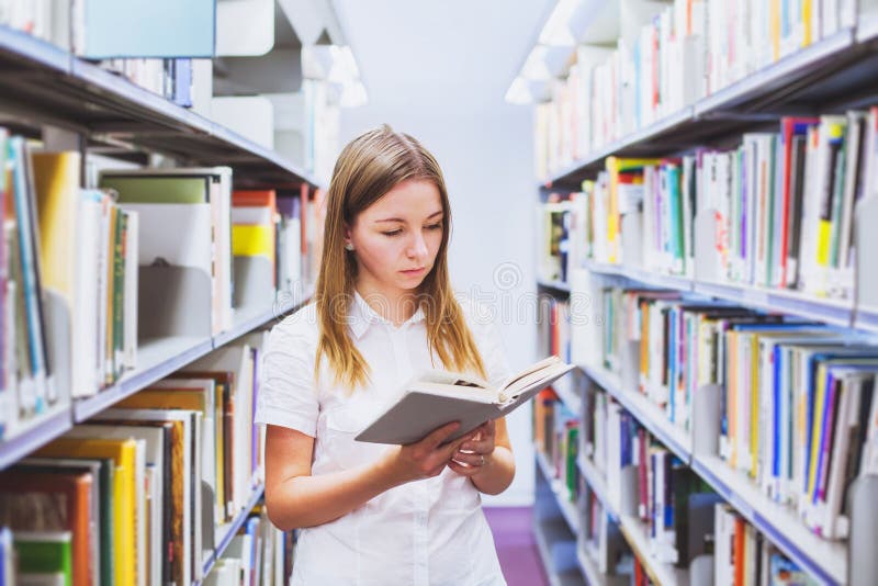 Student Reading Book in Library Stock Photo - Image of library ...