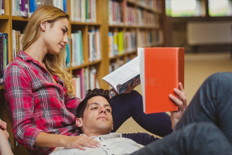Student Reading Book while Lying on His Classmate Stock Photo - Image ...