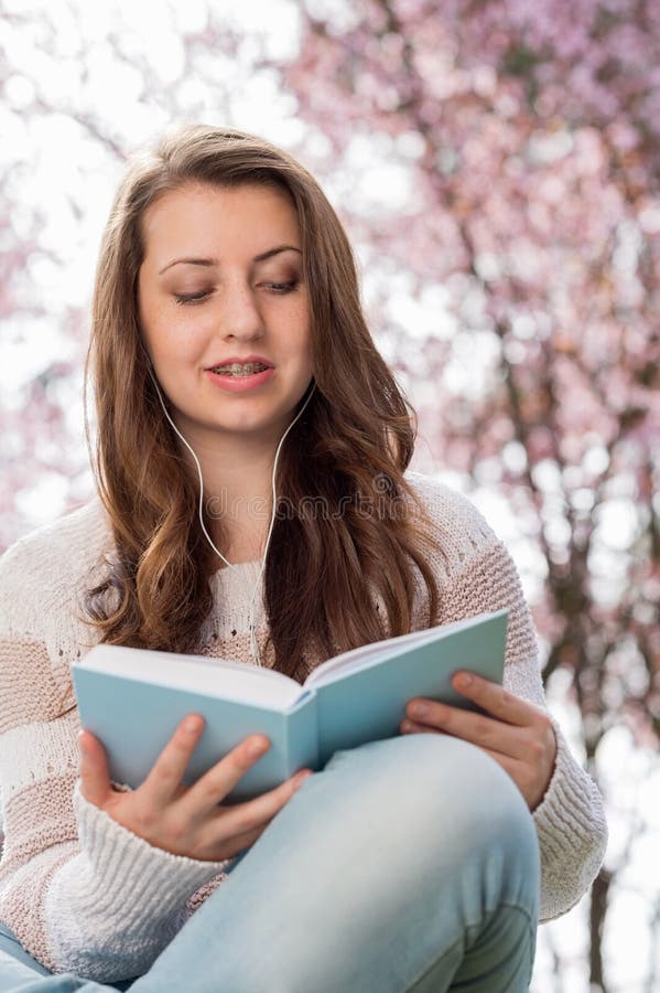 Student Reading Book Near Blossoming Tree Spring Stock Image - Image of ...