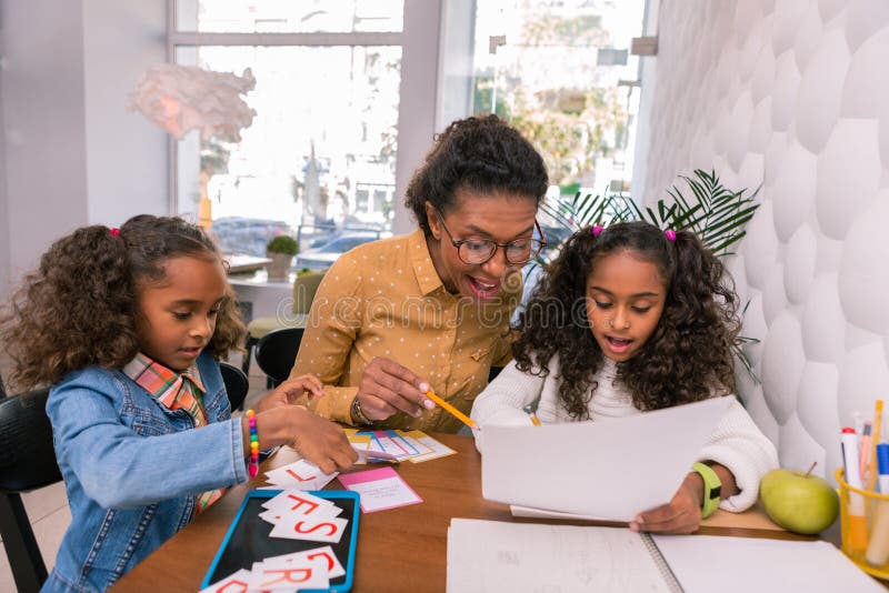 Caring Teacher Wearing Glasses Teaching Her Beautiful Student Reading ...