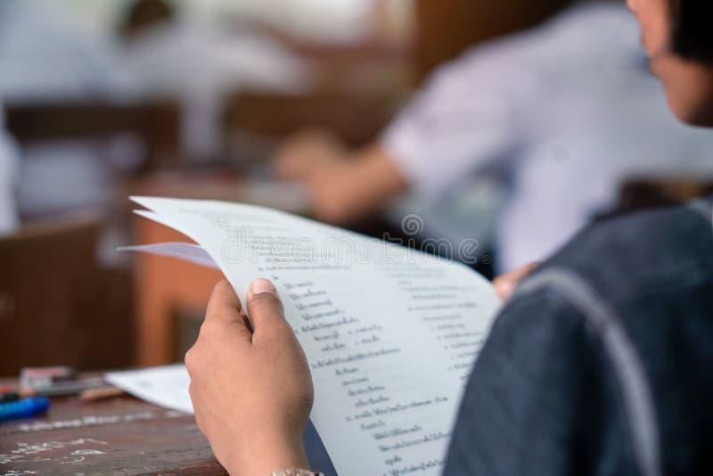 Student Reading and Doing Test or Exam in Classroom of School with ...