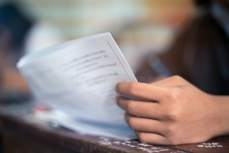 Student Reading and Doing Test or Exam in Classroom of School with ...