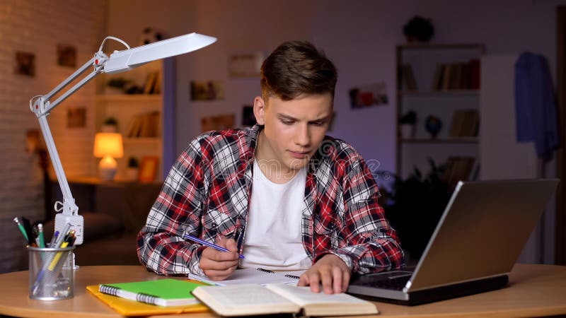 Student Reading Task in Book and Writing Answer Down To Copybook ...