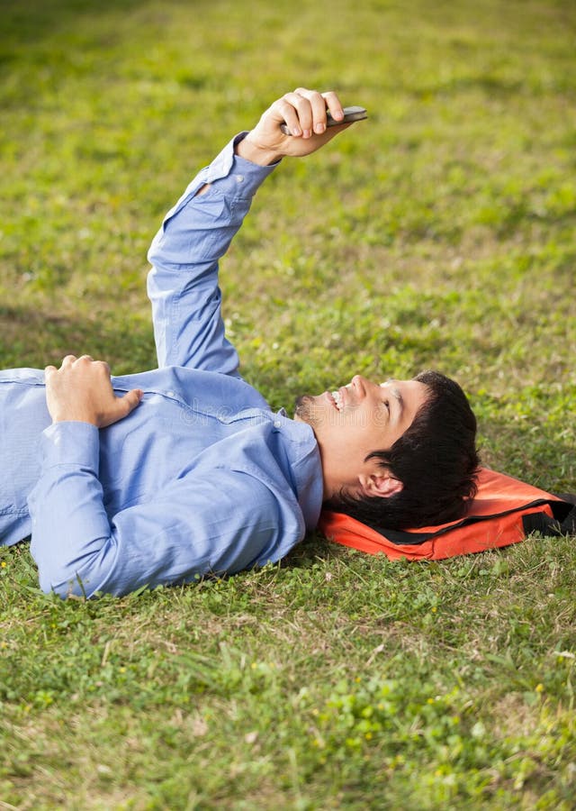 Student Reading Text Message on Mobilephone at Stock Photo - Image of ...