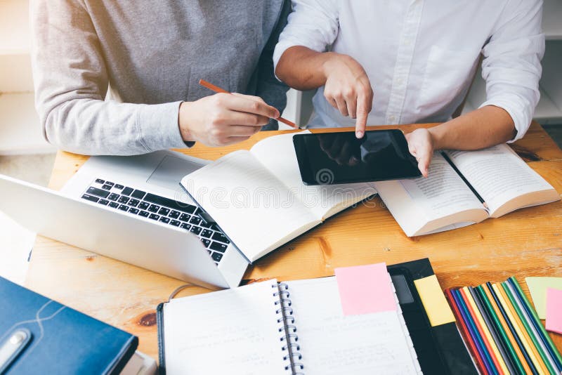 Student Reading Textbook for Test Together in Library Stock Image ...