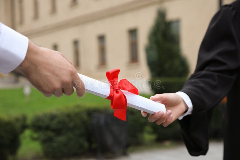 Student Receiving Diploma during Graduation Ceremony Outdoors, Closeup ...