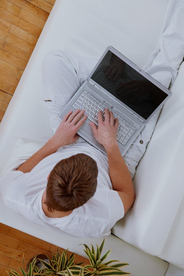 Student Relaxing with His Laptop on a Couch . Stock Photo - Image of ...