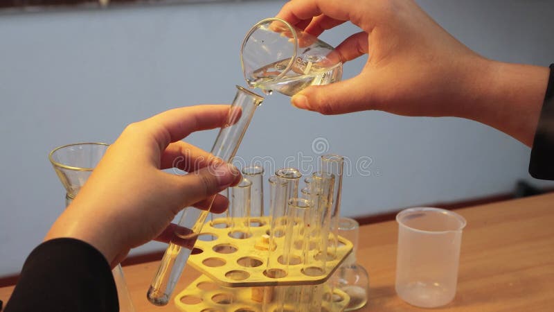 The Student S Hands Dripping a Chemical Solution into a Test Tube Close ...