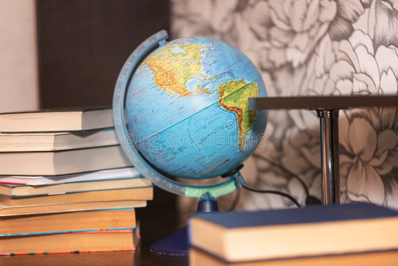 The Student S Homework Table is Filled with Books and a Globe Stock ...