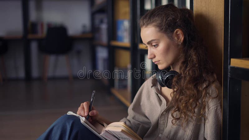 Student S Sitting Against Bookshelf Writing Notes into Notepad Stock ...