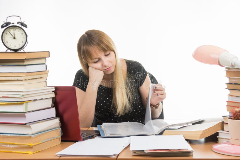 Student Sadly Looking at Turning Pages in a Folder at the Desk among ...