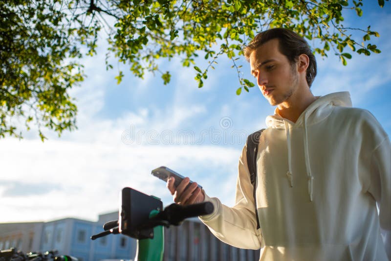 Student Scanning the Electric Scooter S QR-code by Phone. Stock Image ...