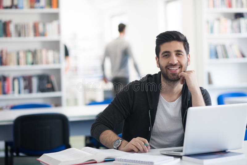 Student in School Library Using Laptop for Research Stock Photo - Image ...