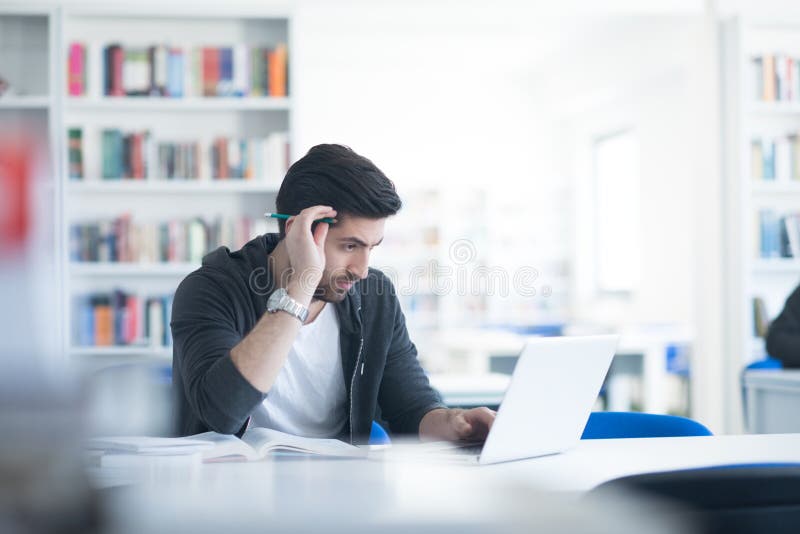 Student in School Library Using Laptop for Research Stock Photo - Image ...
