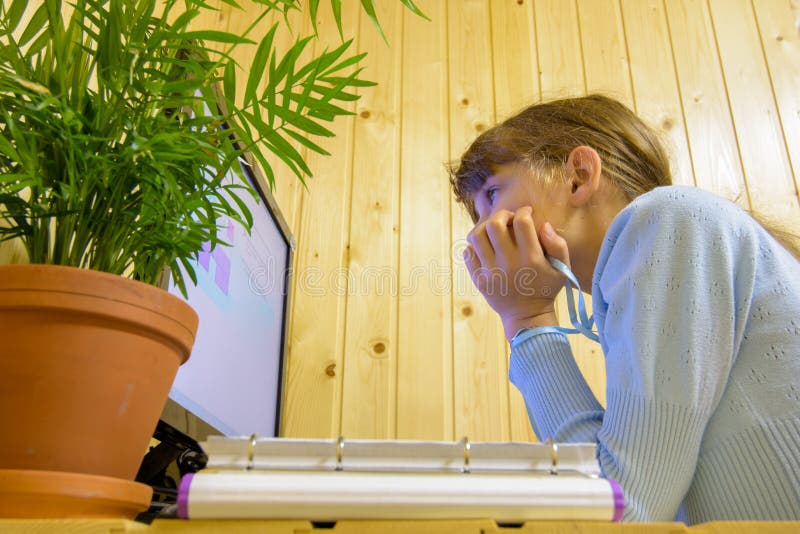 A Student Sits in Front of the Computer during Distance Learning and ...