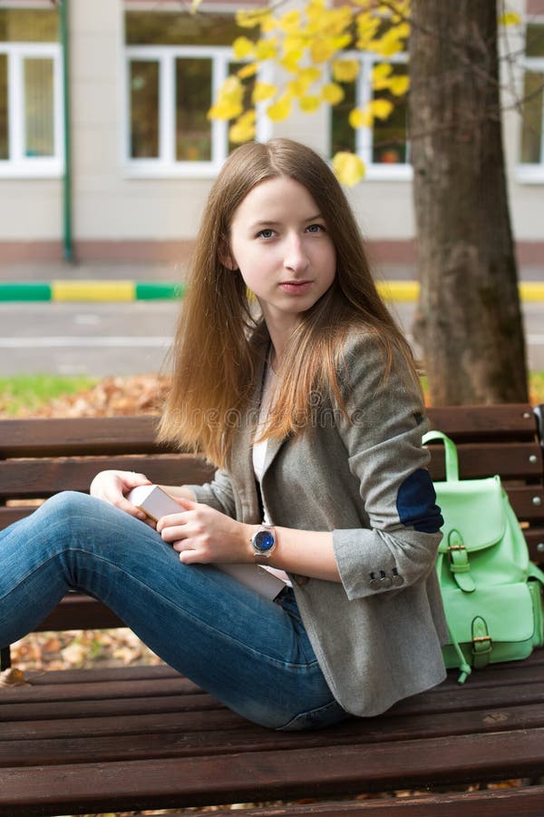 Student sitting on bench stock image. Image of book, high - 56019667