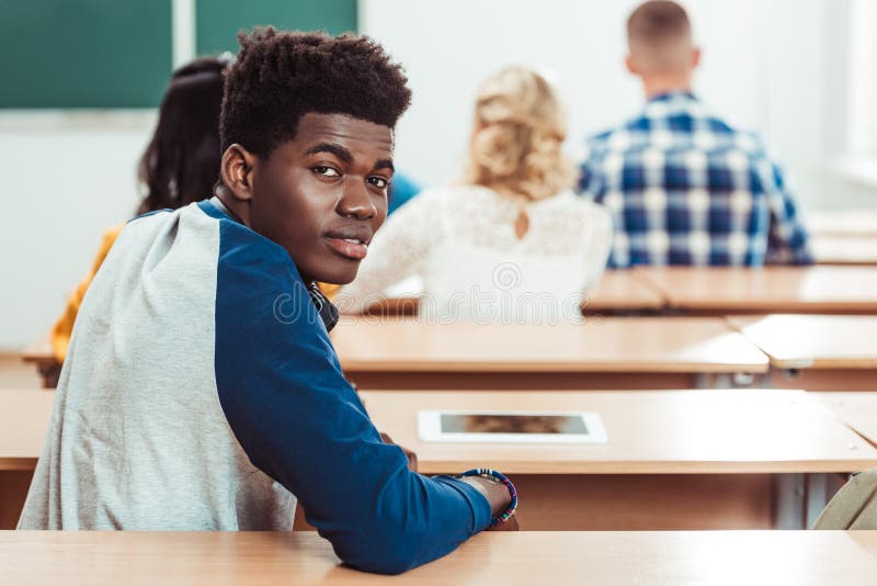 African American Student Sitting in Classroom and Looking Back Stock ...