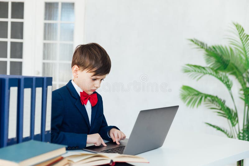Student Sitting in the Classroom at a Laptop with Books in the Office ...