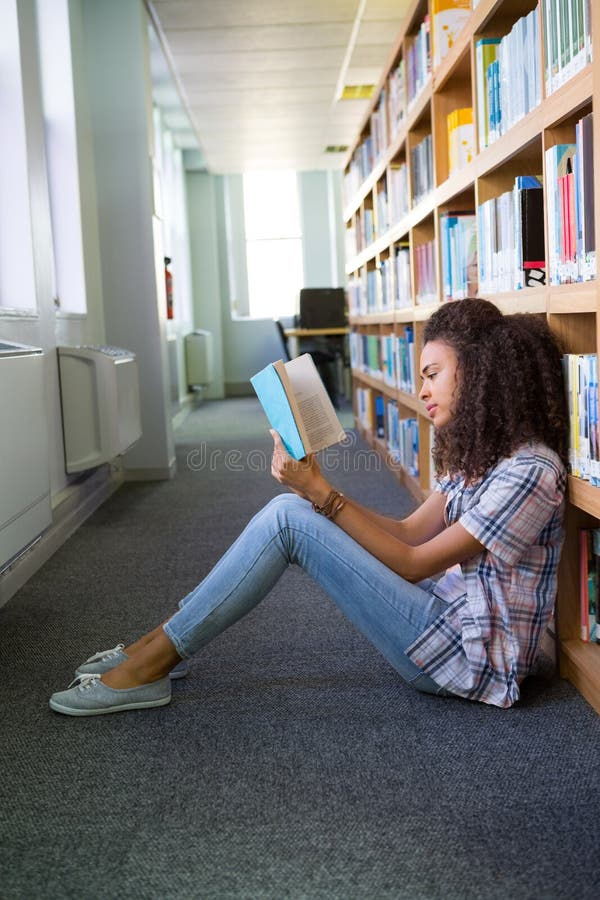 Student Sitting on Floor in Library Reading Stock Photo - Image of ...