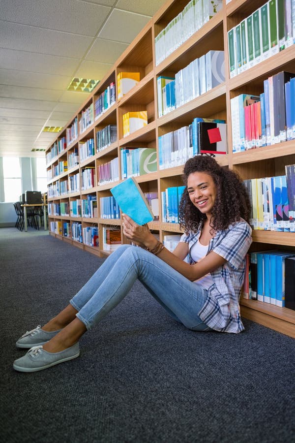 Student Sitting on Floor in Library Reading Stock Photo - Image of ...
