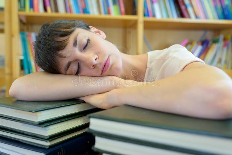 Student Sleeping on Books in Library Stock Photo - Image of sleep ...
