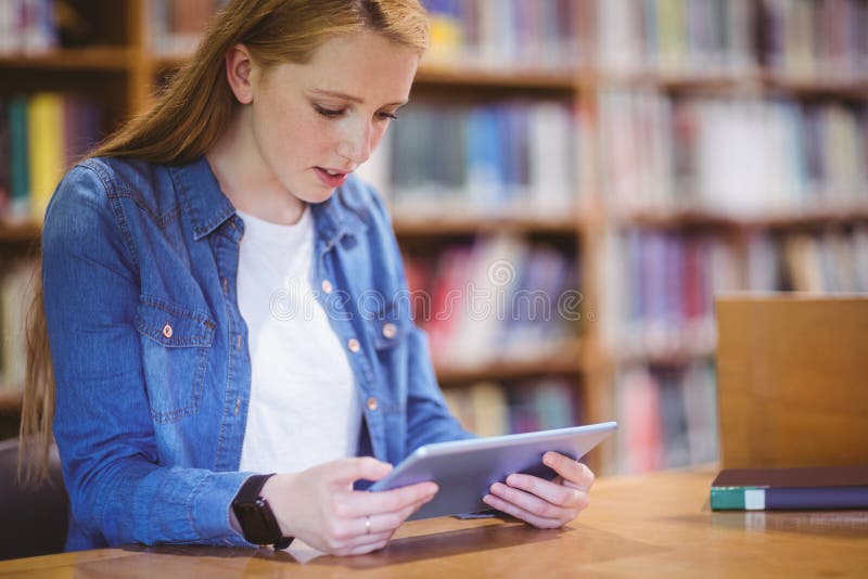 Student with Smartwatch Using Tablet in Library Stock Image - Image of ...