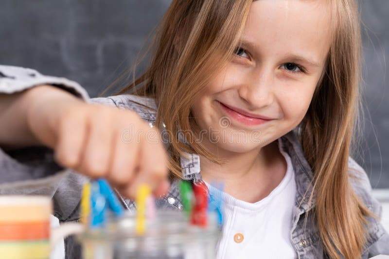 With a Student Smile on Her Face at School, the Girl is Sitting in the ...