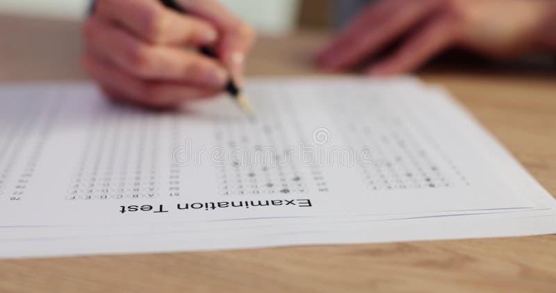 Student Solving Tests and Crossing Out Correct Answers with Pencil on ...