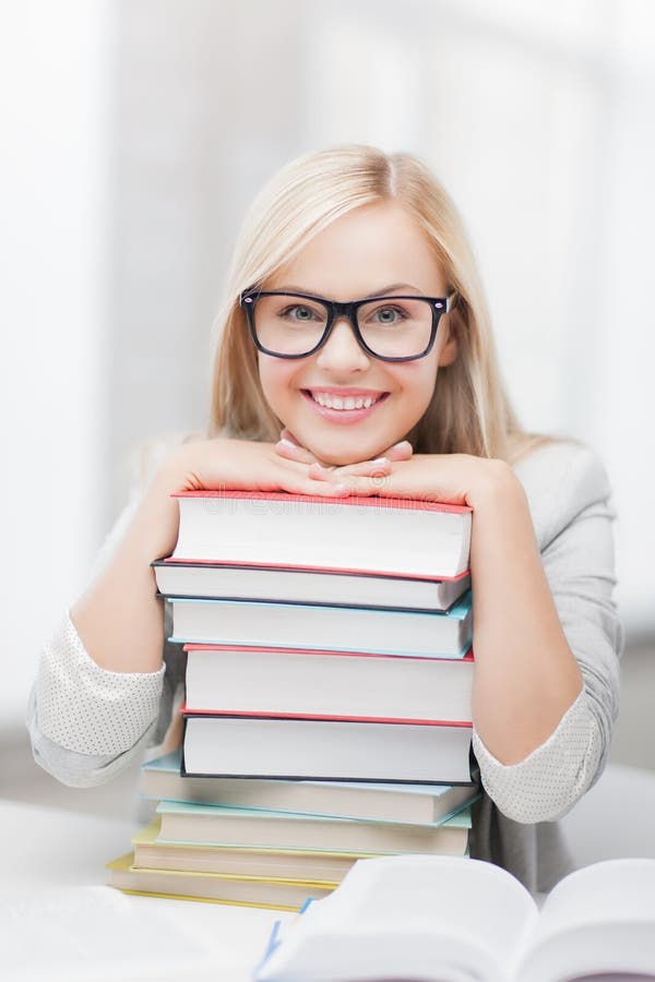 Student with Stack of Books Stock Photo - Image of holding, cheerful ...