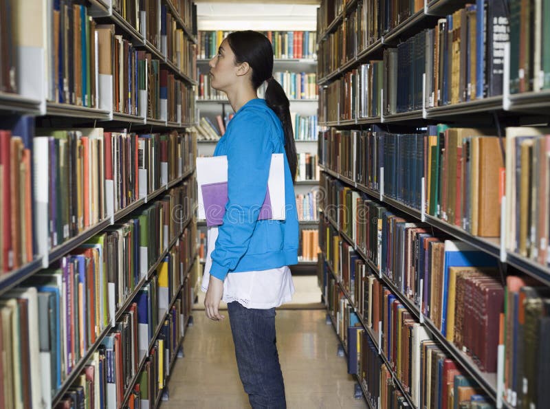 Student Standing by Bookshelf in Library Stock Photo - Image of ...