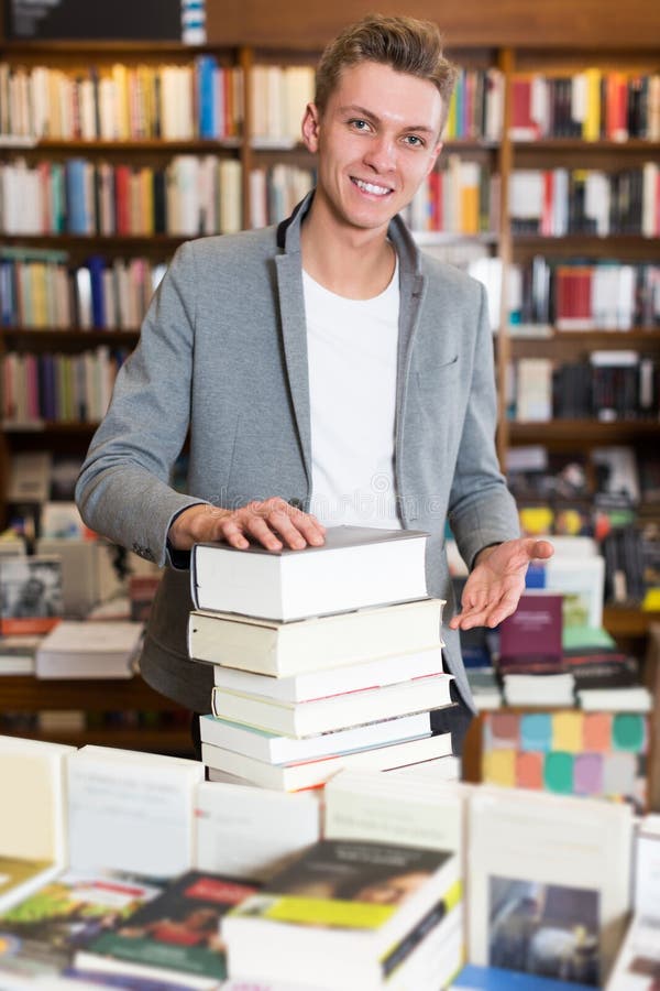Student Standing in Library with Pile of Books Stock Image - Image of ...
