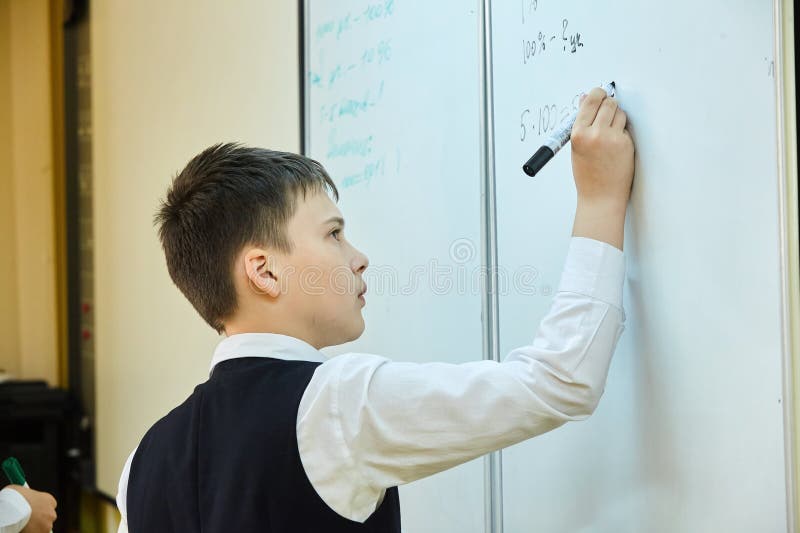 A Student Stands at the Blackboard and Writes a Task. Stock Image ...