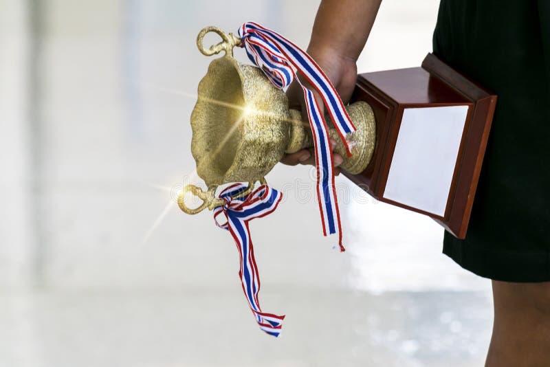 The Student Stands Holding the Trophy Received from the Competition ...