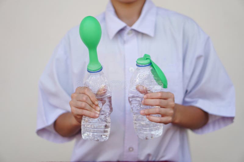 Student Study Science Experiment, Hold Two Bottles with Green Balloons ...